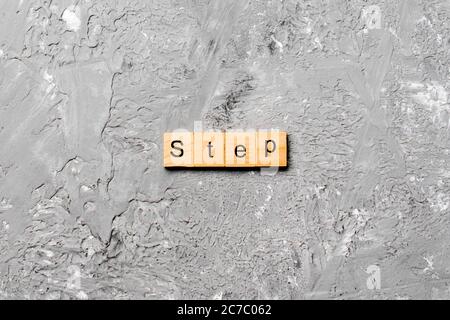 step by step word written on wood block. step by step text on table ...