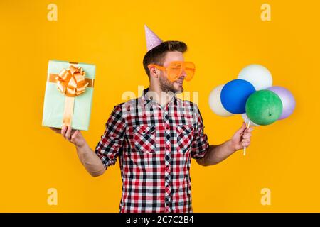 Real shopaholic. guy hold festive balloons. happy holiday celebration ...
