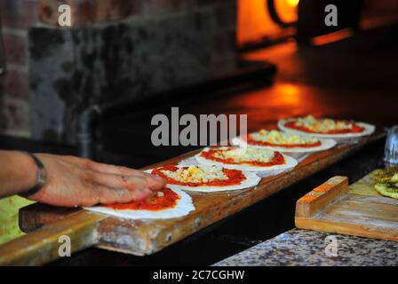 Damascus, Syria. 16th July, 2020. A baker makes cheese pies in Damascus ...