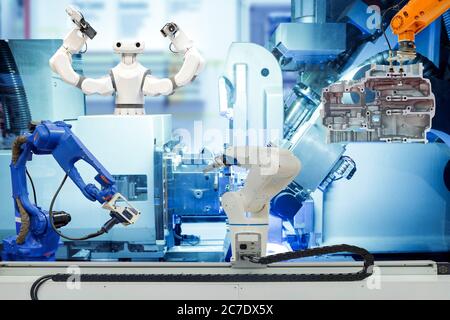 Industrial robotics teamwork on working with CNC lathe machine in smart ...