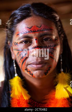 An indigenous Brazilian woman with traditional face paint exploring a ...