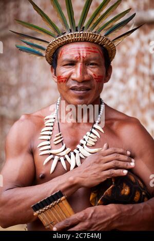 Indigenous man wearing a feather headdress, Quito, Pichincha Province ...