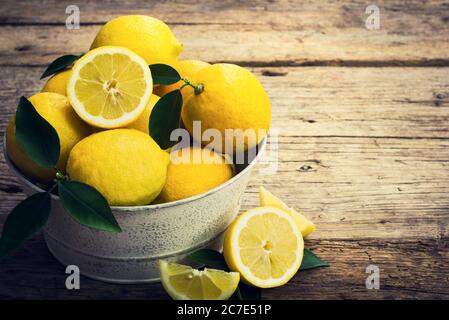 Fresh lemons on the rustic tale Stock Photo - Alamy