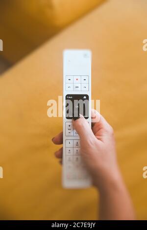 A vertical shot of a hand with a smart watching holding a floral ...