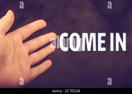Hand making welcome gesture saying come in Stock Photo - Alamy