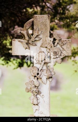 A vertical shot of a granite stone cross in a park Stock Photo - Alamy