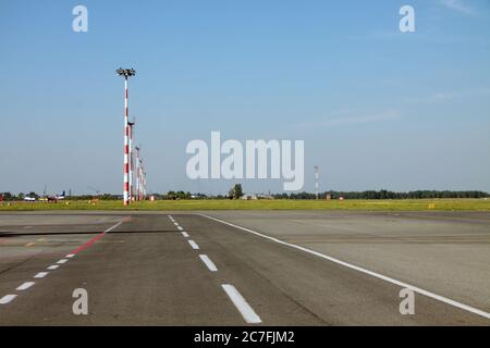 lighting masts by a take-off runway of an airport. Airspace industry ...
