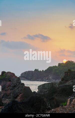 A vertical shot of the beautiful sunset at Kerala public property beach ...