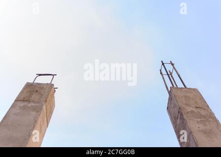 Unfinished concrete column under tower construction with protruded ...