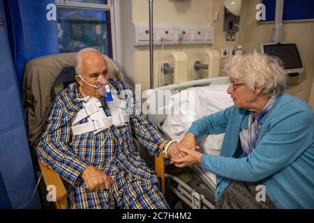 Elderly old man recovering in a hospital bed isolated on white ...