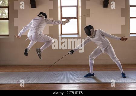SPORTS Fencing competition two male foil competitors talking on strip ...