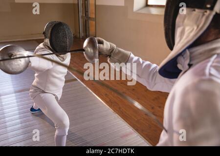 SPORTS Fencing competition two male foil competitors talking on strip ...