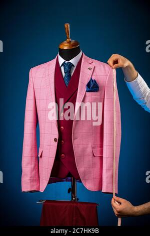 Young hispanic man dressmaker designer using smartphone smiling happy ...