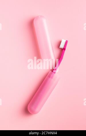 New pink toothbrush on pink background Stock Photo - Alamy
