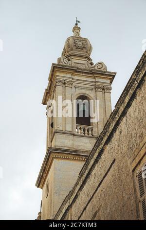 Church bell tower made of bricks amid rooftops and countryside ...