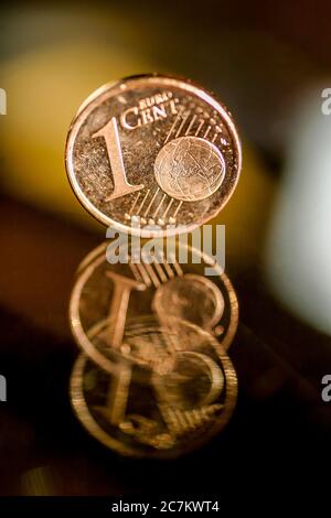 Different Euro coins balance on a glass table Stock Photo - Alamy