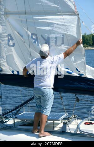 Yachtsman checking sail before regatta Stock Photo - Alamy