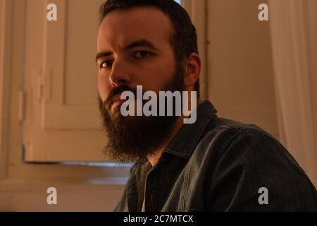 Beautiful caucasian bearded man in black clothes on blue yogamat doing ...