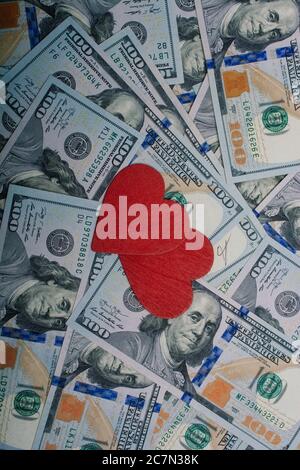 Red hearts on dollar bills. Concept of selling love for money Stock ...