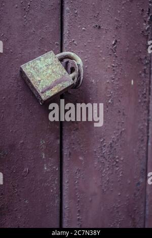Lock attached to the doors of dark violet color Stock Photo - Alamy