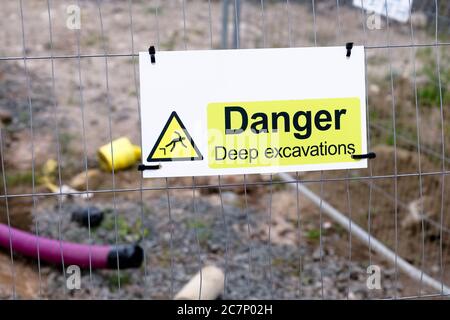 Excavation and safety fence deep in road works and piling of hole Stock ...