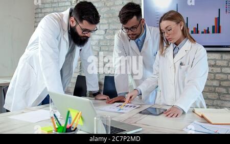 Group of doctors discussing possible solutions for resolving Covid-19 ...