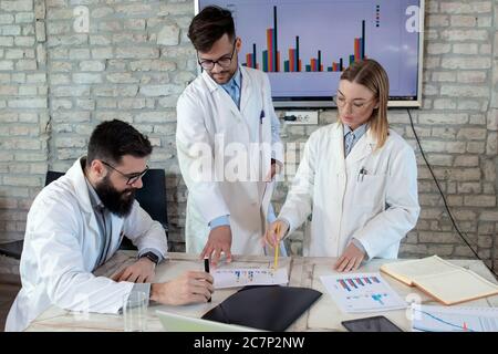 Group of doctors discussing possible solutions for resolving Covid-19 ...