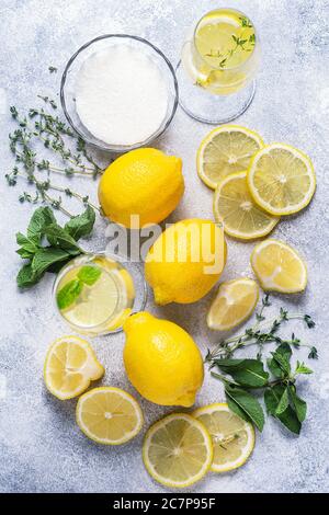 refreshing drink lemonade with lemons, mint leaves, lime in a glass ...