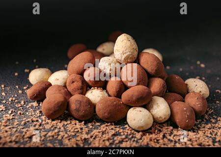 Different tasty chocolate nuts on white background Stock Photo - Alamy