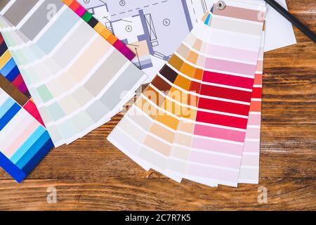 Color palettes with building plan on wooden background Stock Photo - Alamy