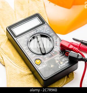 Closeup shot of a digital multimeter with black and red wires attached ...
