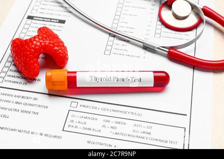 Endocrinology. Stethoscope and model of thyroid gland on light blue ...