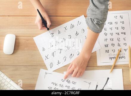Hand lettering, modern calligraphy alphabet in black on a white paper ...