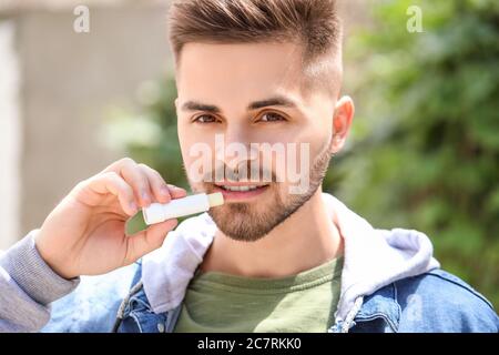 Man applying lip balm Stock Photo - Alamy
