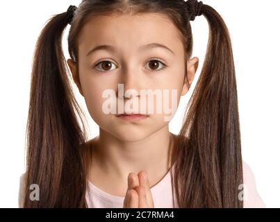 Apologizing little girl on white background Stock Photo - Alamy