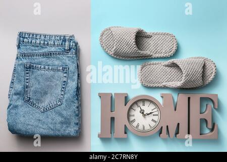 Soft slippers, clothes and decorative clock on color background Stock ...