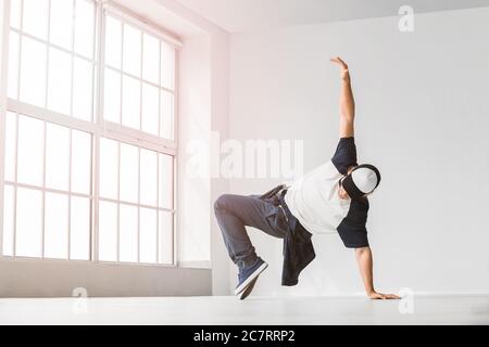 Male hip-hop dancer in modern studio Stock Photo - Alamy