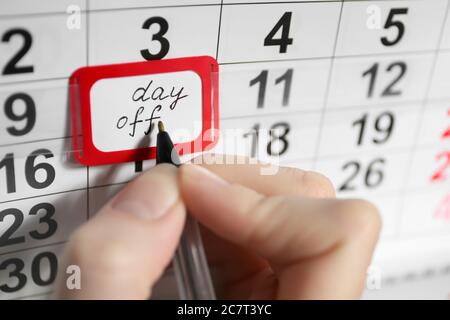 Woman marking day off in calendar, closeup Stock Photo - Alamy