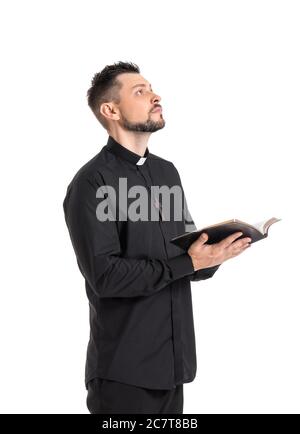 Handsome priest with Bible on white background Stock Photo - Alamy
