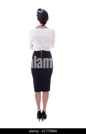 Rear view of young flight attendant walking in airport with lens flare ...
