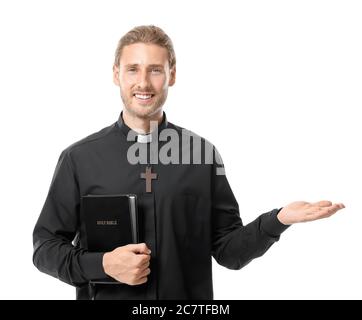 Handsome priest with Bible on white background Stock Photo - Alamy