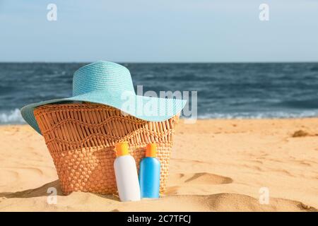 Beach bag, sun hat, cosmetics, denim shorts, camera, seashells on old ...