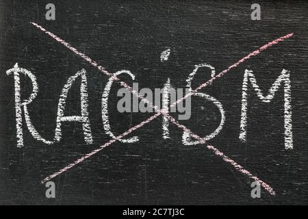Chalkboard with crossed out word RACISM and placards Stock Photo - Alamy