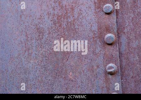 Fragment Rusty riveted hull of an old ship. Large metal rivets metal ...