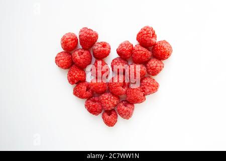 Ripe raspberries heart shaped composition isolated on white background ...