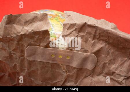 Earth with bandaided paper Solidarity and aid to countries in need ...