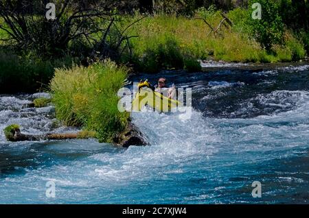 Kayak tipping over while going over the rapids Stock Photo - Alamy