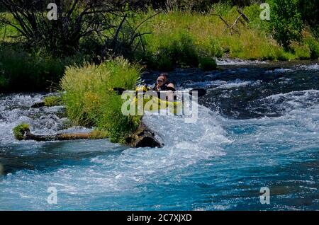 Kayak tipping over while going over the rapids Stock Photo - Alamy