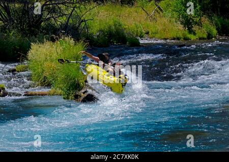 Kayak tipping over while going over the rapids Stock Photo - Alamy