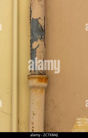 Vertical picture of a rustic pipe on the wall Stock Photo - Alamy